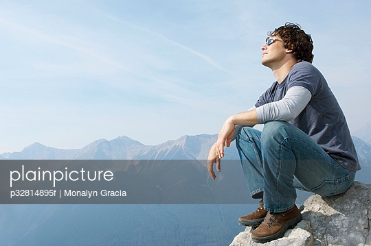 Man looks out from a mountain top - Stock Image - Everypixel