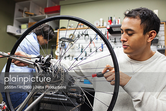 Technicians fixing bicycles in repair shop - Stock Image - Everypixel