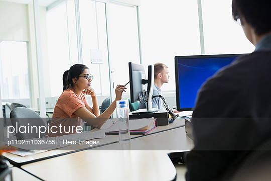 College students studying at computers in classroom - Stock Image ...