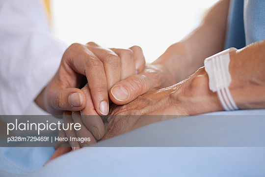 Closeup of doctor holding patient's hand. - Stock Image - Everypixel