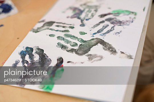 Painted hand prints on paper - Stock Image - Everypixel