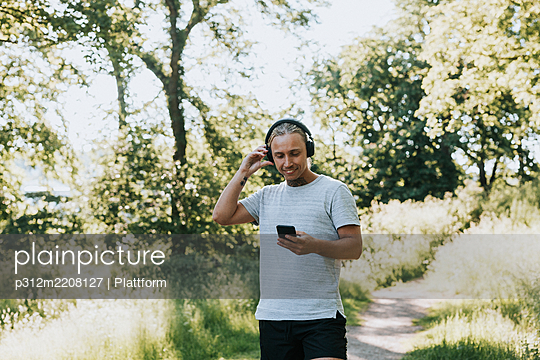 Smiling checking phone - Stock Image - Everypixel