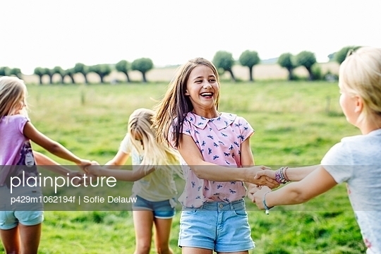 Girls dancing on field, Flanders, Belgium - Stock Image - Everypixel