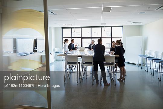 Business people standing in conference room meeting - Stock Image ...