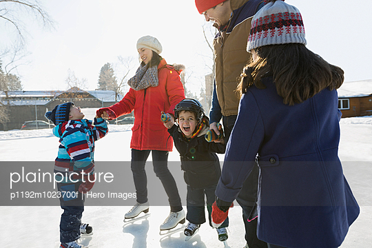 Cheerful family ice-skating on rink - Stock Image - Everypixel