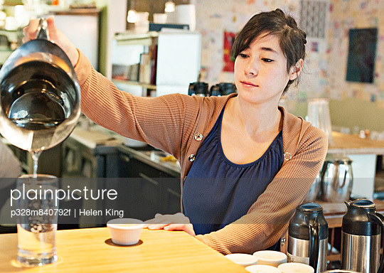Waitress pours out water - Stock Image - Everypixel