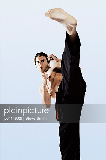 Man practicing martial arts and kicking - Stock Image - Everypixel