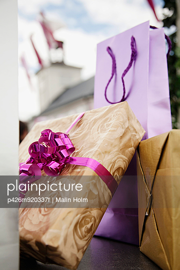 Wrapped gift boxes and paper bag on table - Stock Image - Everypixel