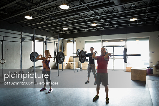 Exercise class weightlifting with barbells at gym - Stock Image ...