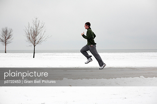 Young man running outdoors in winter - Stock Image - Everypixel