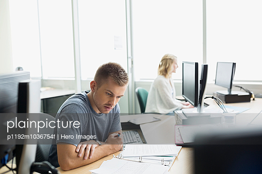 College students studying at computers in classroom - Stock Image ...