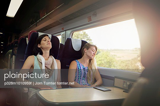 Young women sleeping on train - Stock Image - Everypixel