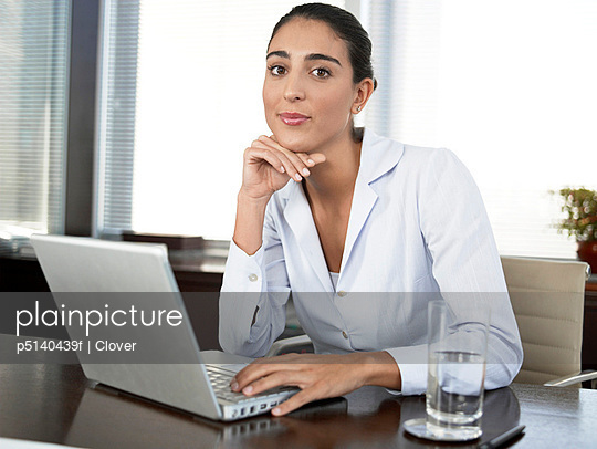 Businesswoman using laptop computer (portrait) - Stock Image - Everypixel