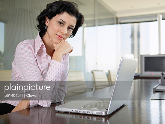 Young businesswoman using laptop computer (portrait) - Stock Image ...