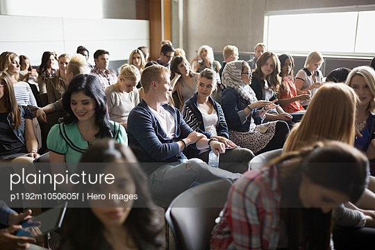Students talking in auditorium audience - Stock Image - Everypixel