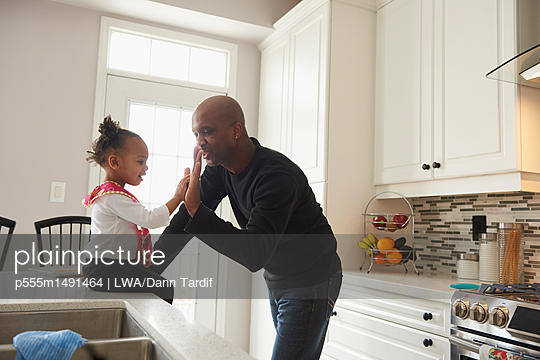 Black father high-fiving daughter - Stock Image - Everypixel