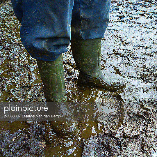 Person with boots standing in the mud - Stock Image - Everypixel