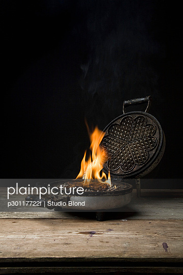 A waffle iron on fire - Stock Image - Everypixel