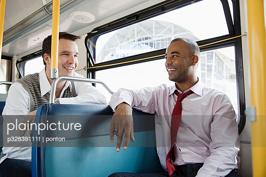 Businessmen chatting while riding public bus - Stock Image - Everypixel
