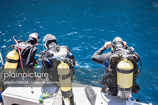 Three Scuba Divers Preparing To Leave Boat For A Dive - Stock Image ...