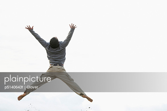 Man and woman jumping (rear view) - Stock Image - Everypixel