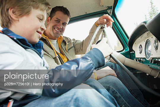 Father teaching son about driving. - Stock Image - Everypixel